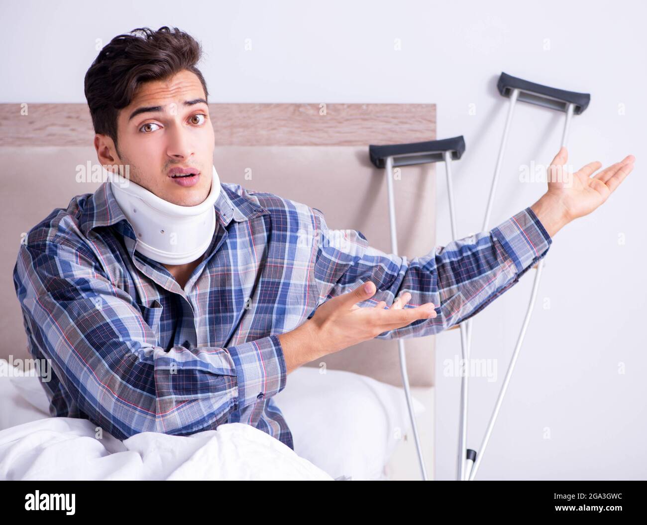 The injured man in bed at home with crutches Stock Photo - Alamy