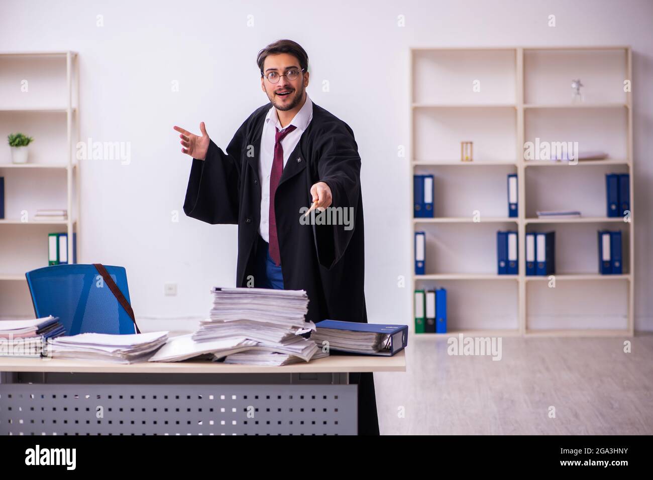 Funny young employee magician and too much work in the office Stock ...