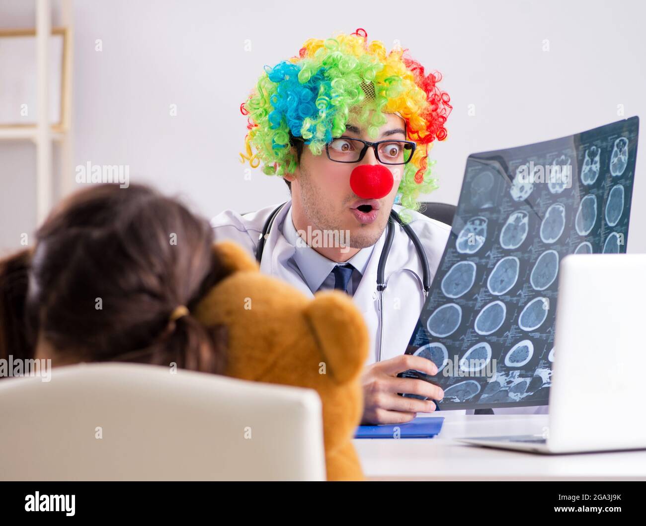 The funny pediatrician with little girl at regular check-up Stock Photo ...
