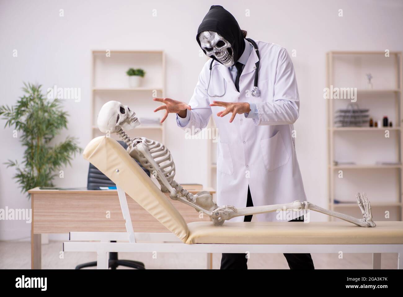 Devil doctor examining skeleton patient in the clinic Stock Photo - Alamy
