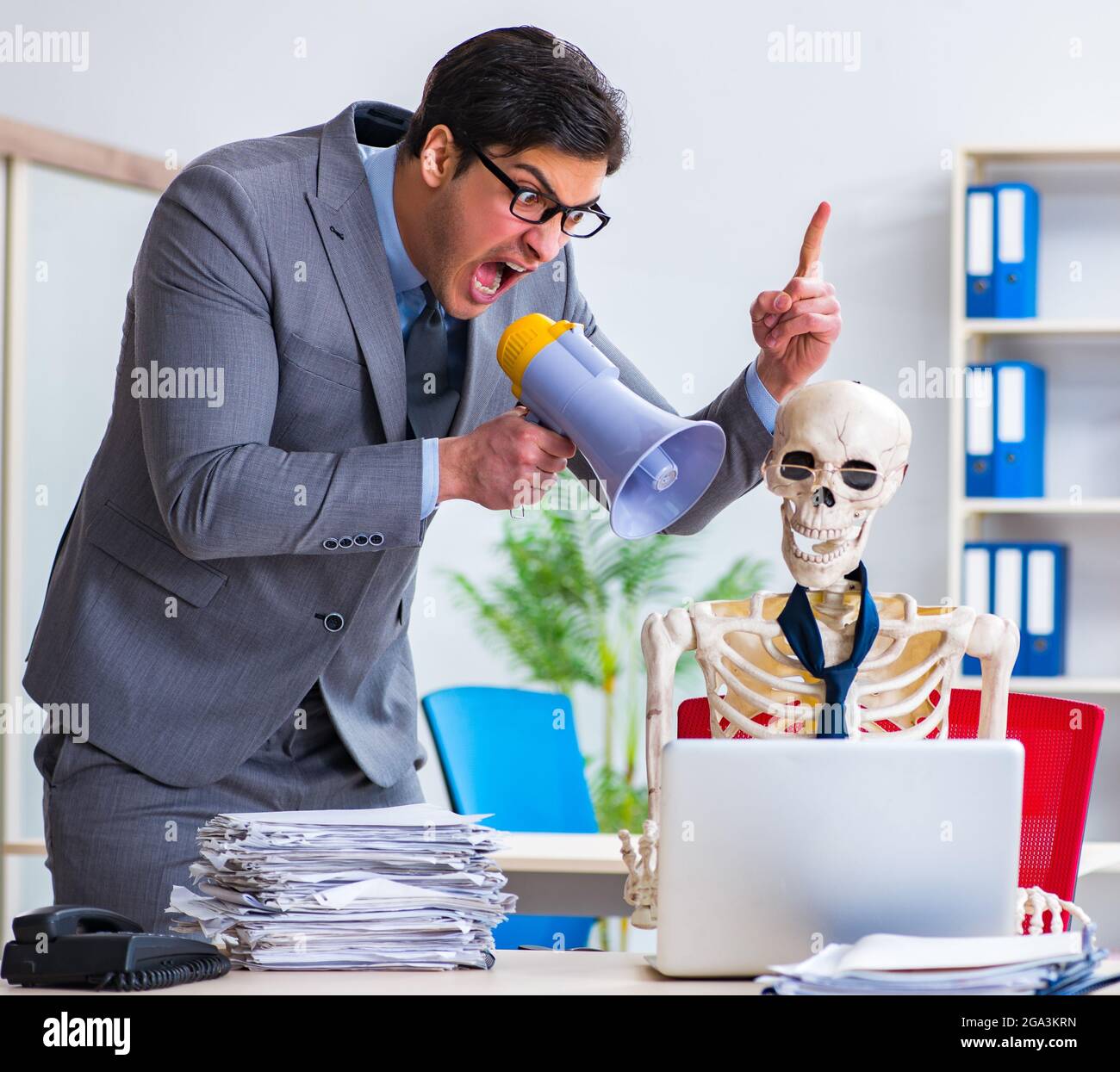 The angry boss yelling at his skeleton employee Stock Photo - Alamy