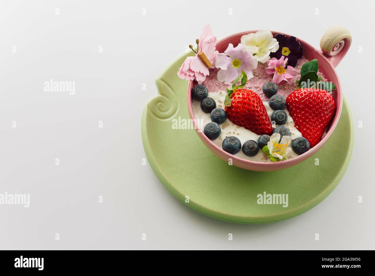Green cup of ice cream with strawberries and blackberries Stock Photo ...