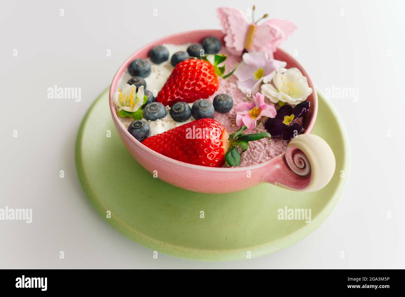 Green cup of ice cream with strawberries and blackberries Stock Photo ...