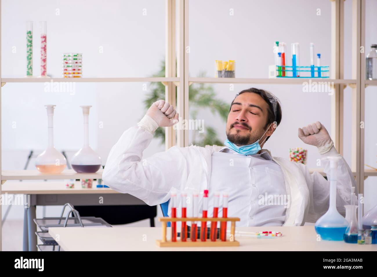 Young chemist extremely tired at the lab Stock Photo - Alamy