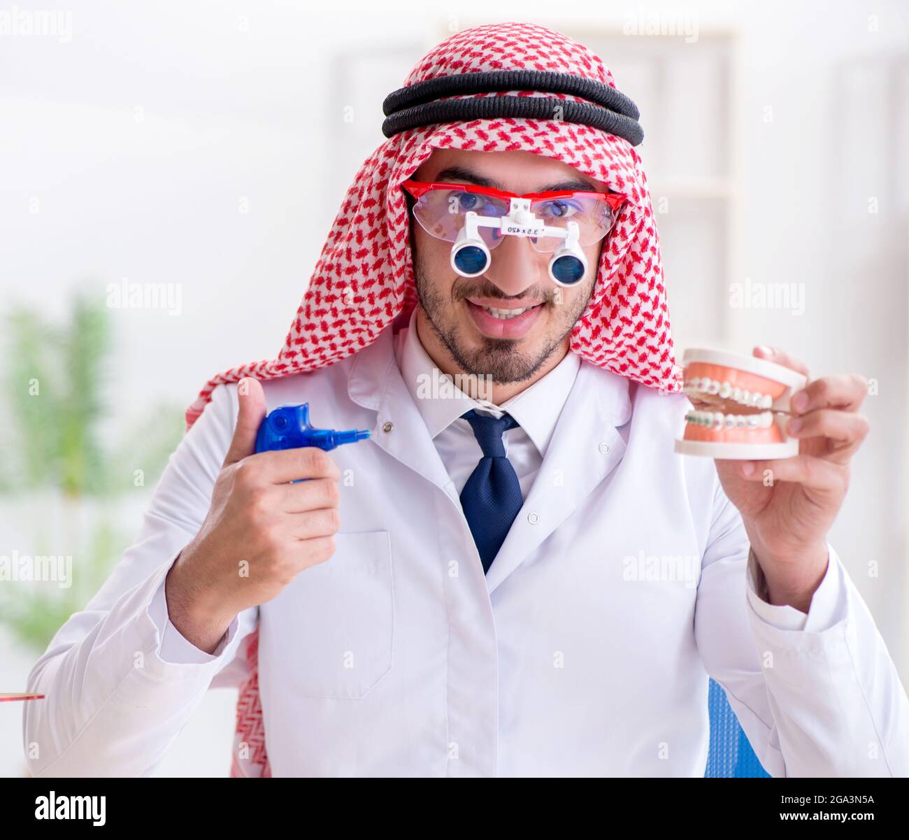 The arab dentist working on new teeth implant Stock Photo - Alamy
