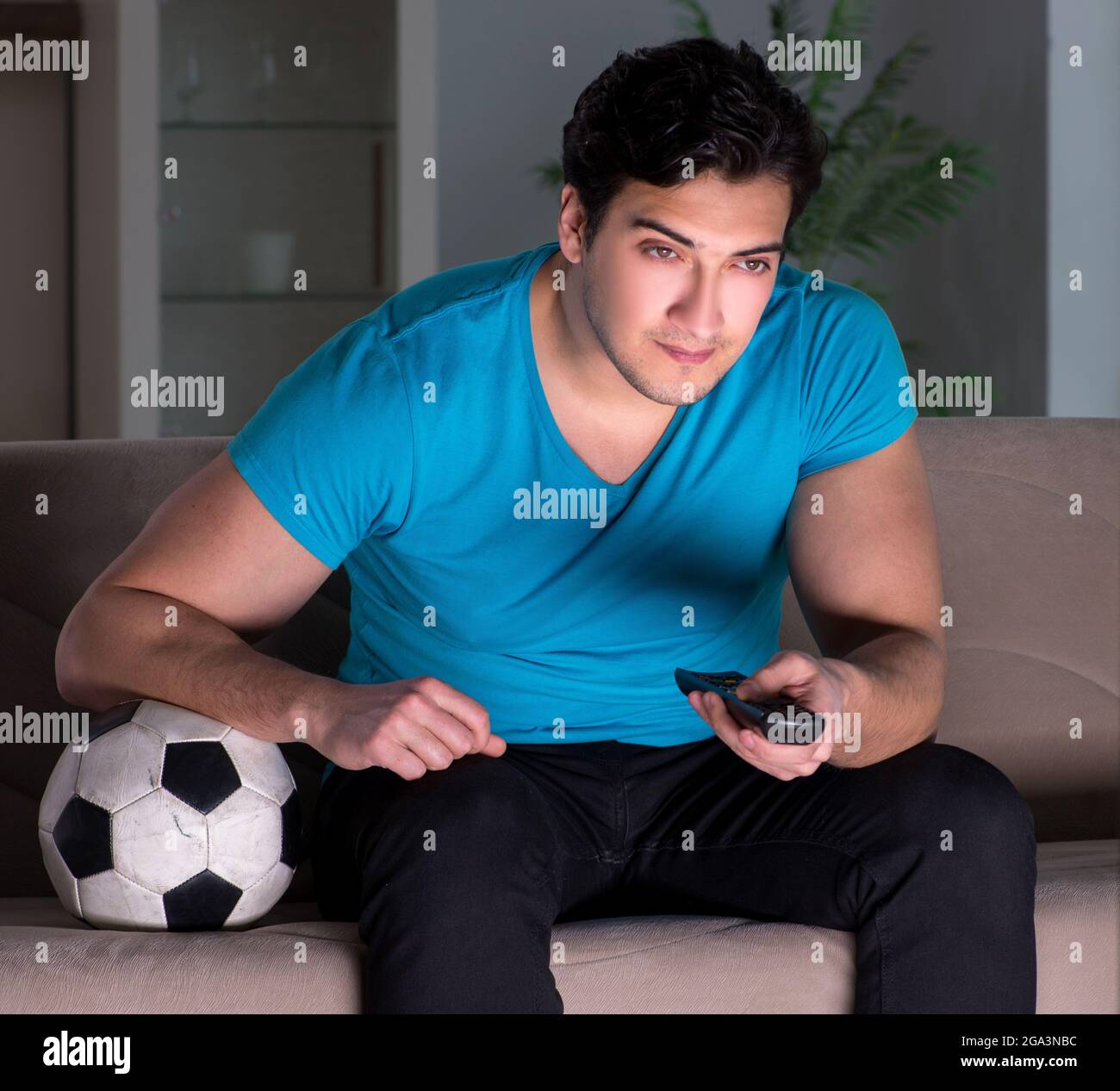 The young man watching football late at night Stock Photo - Alamy