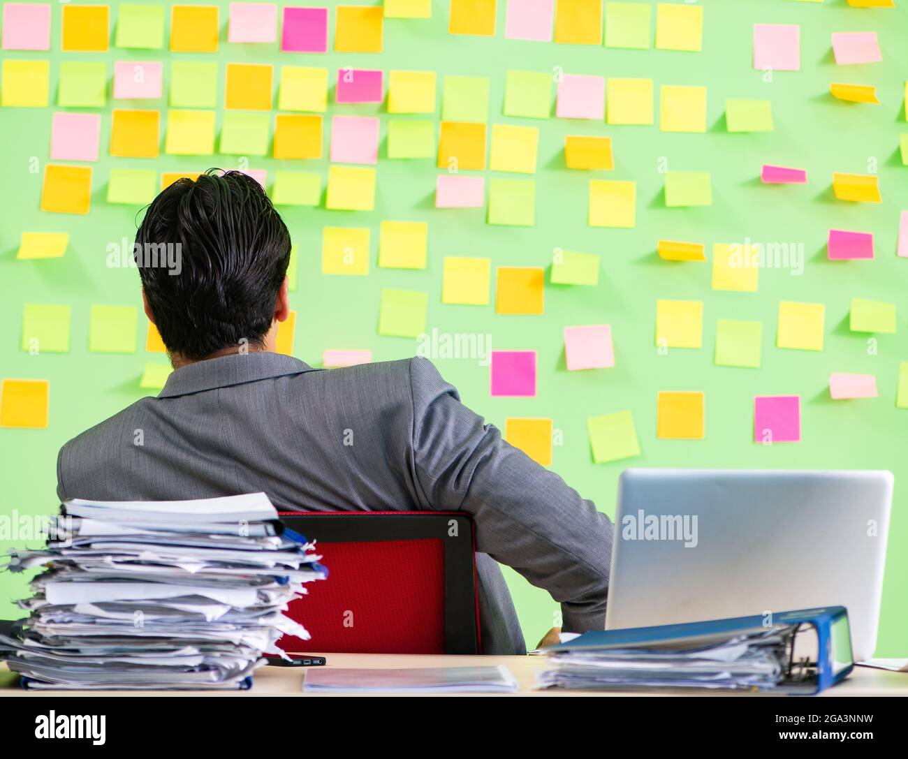 The businessman having trouble with his priorities Stock Photo - Alamy