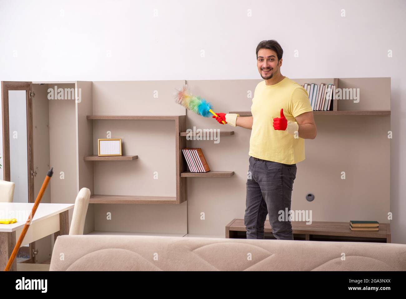 Young male cleaner cleaning the house Stock Photo - Alamy