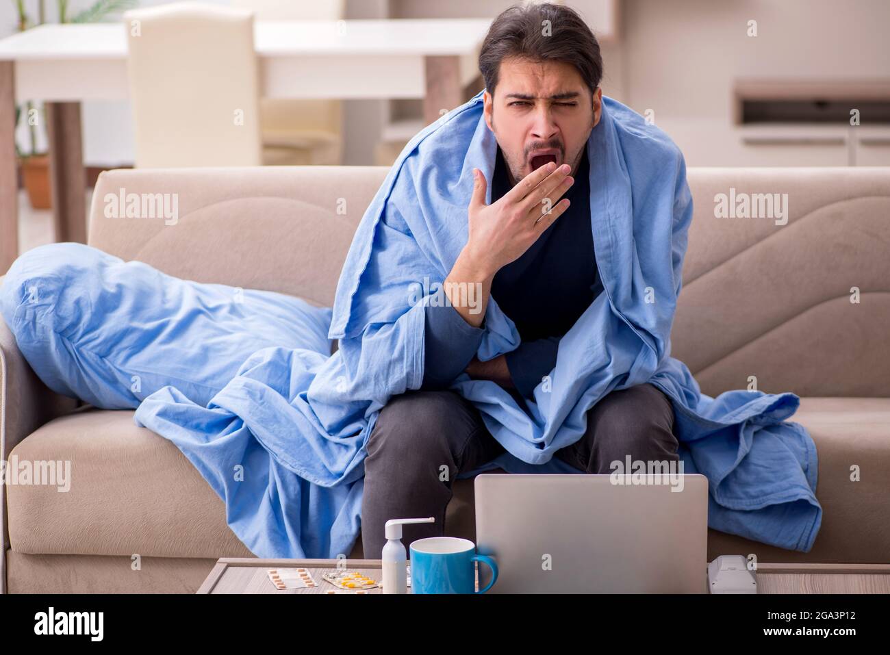 Young man feeling bad at home during pandemic Stock Photo - Alamy