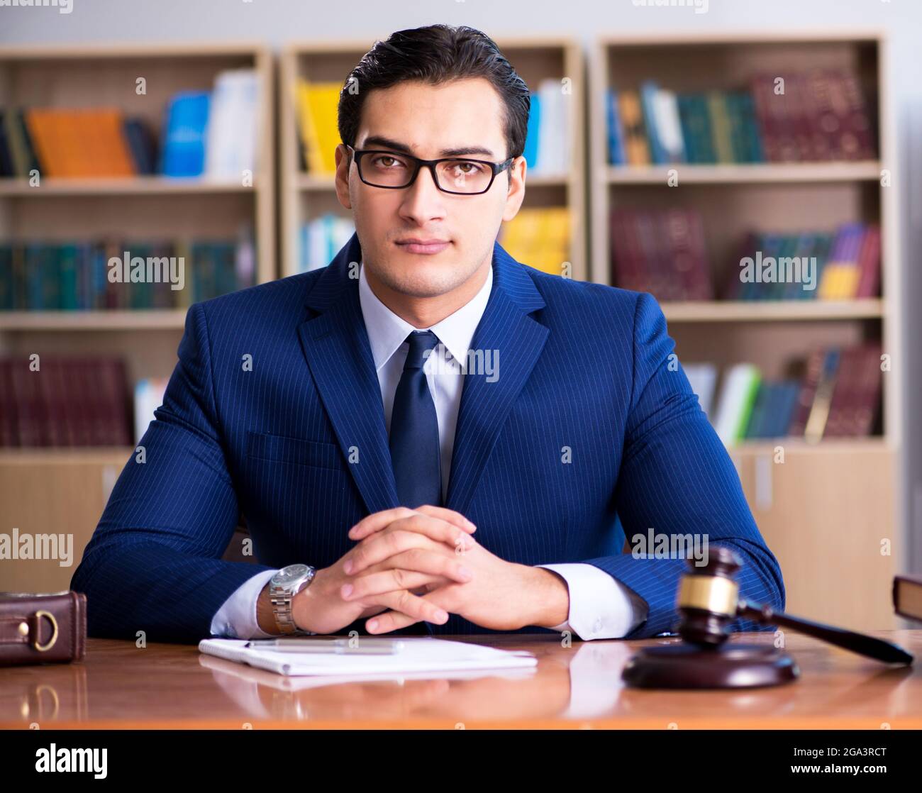 The handsome judge with gavel sitting in courtroom Stock Photo - Alamy