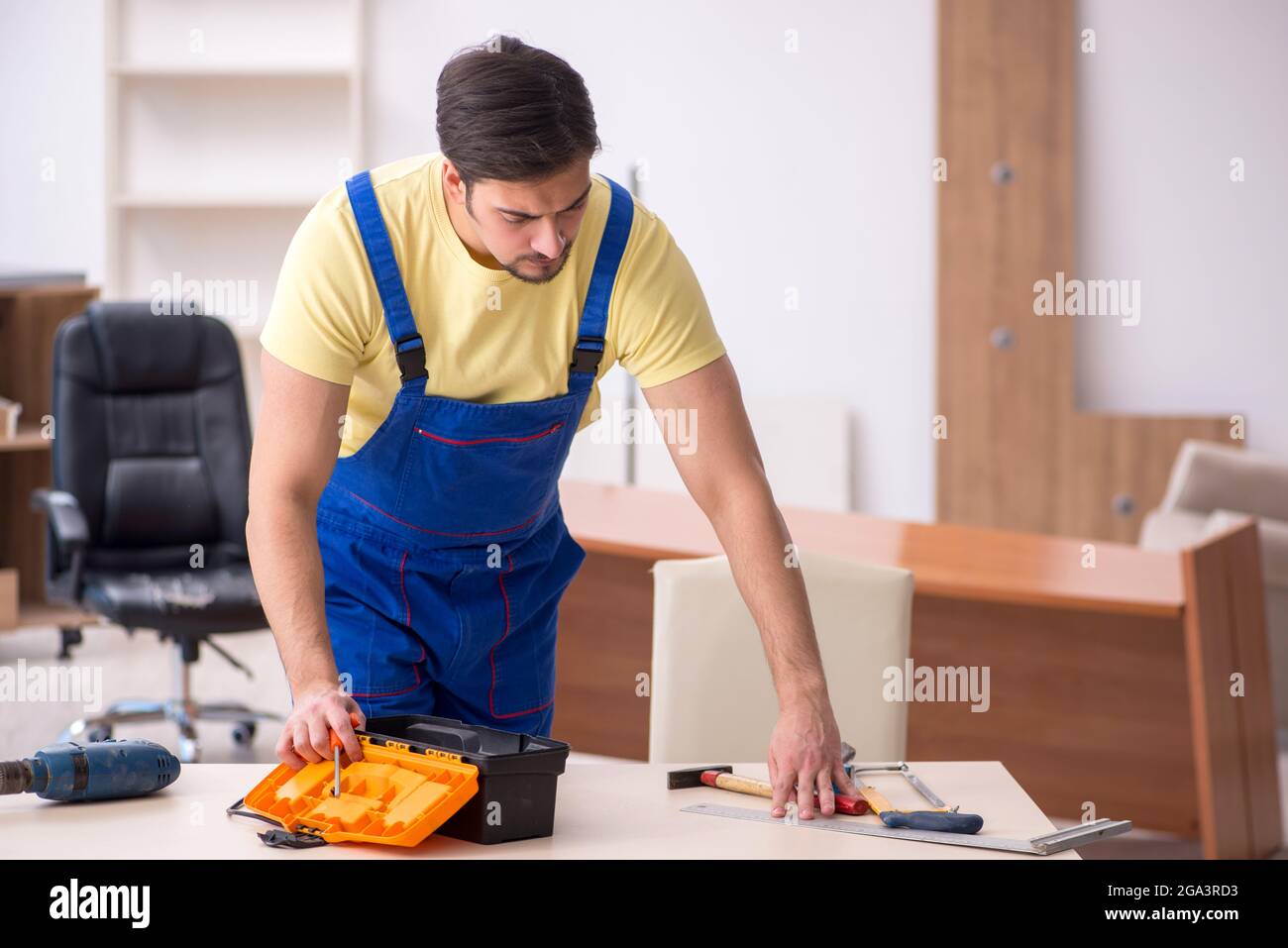 Young carpenter working in the office Stock Photo - Alamy