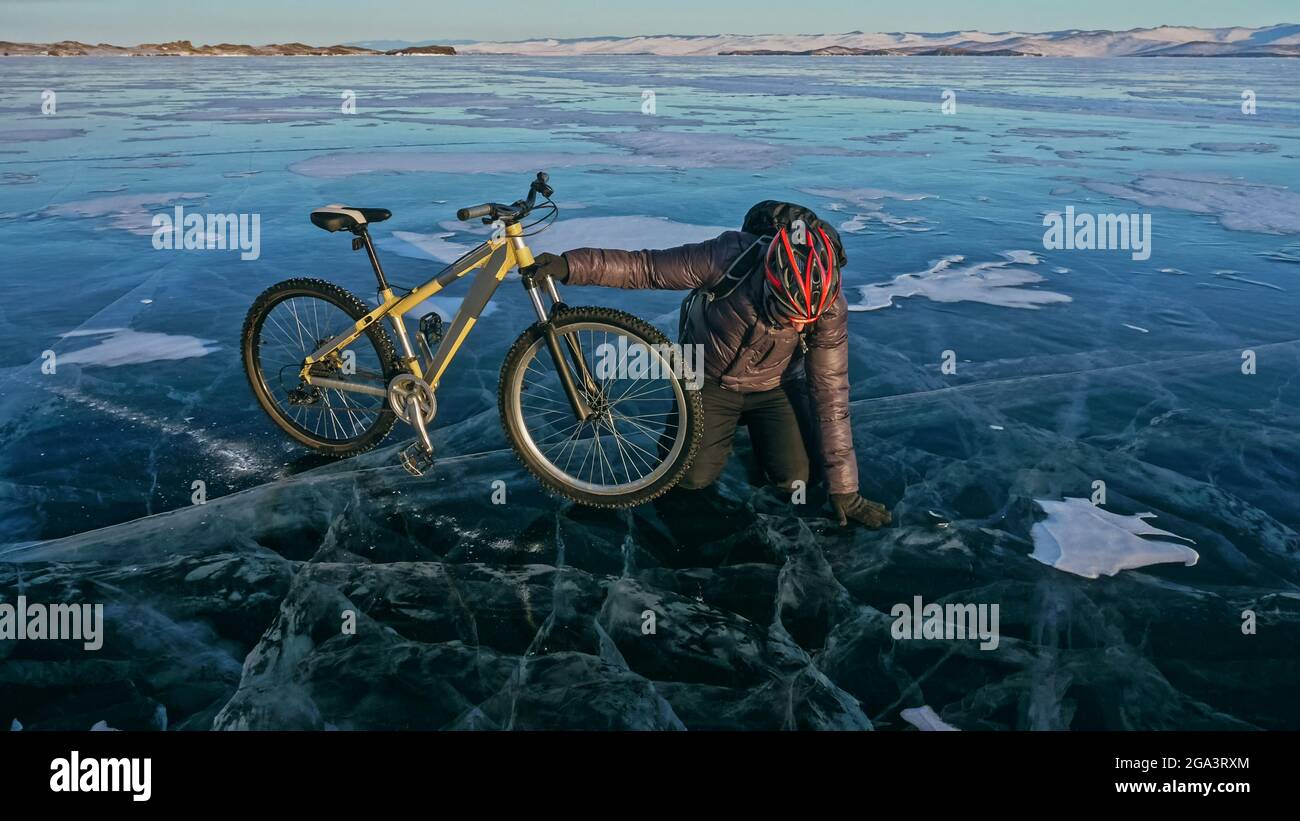Man is riding bicycle on the ice. Ice of frozen Lake Baikal. Rid Stock ...