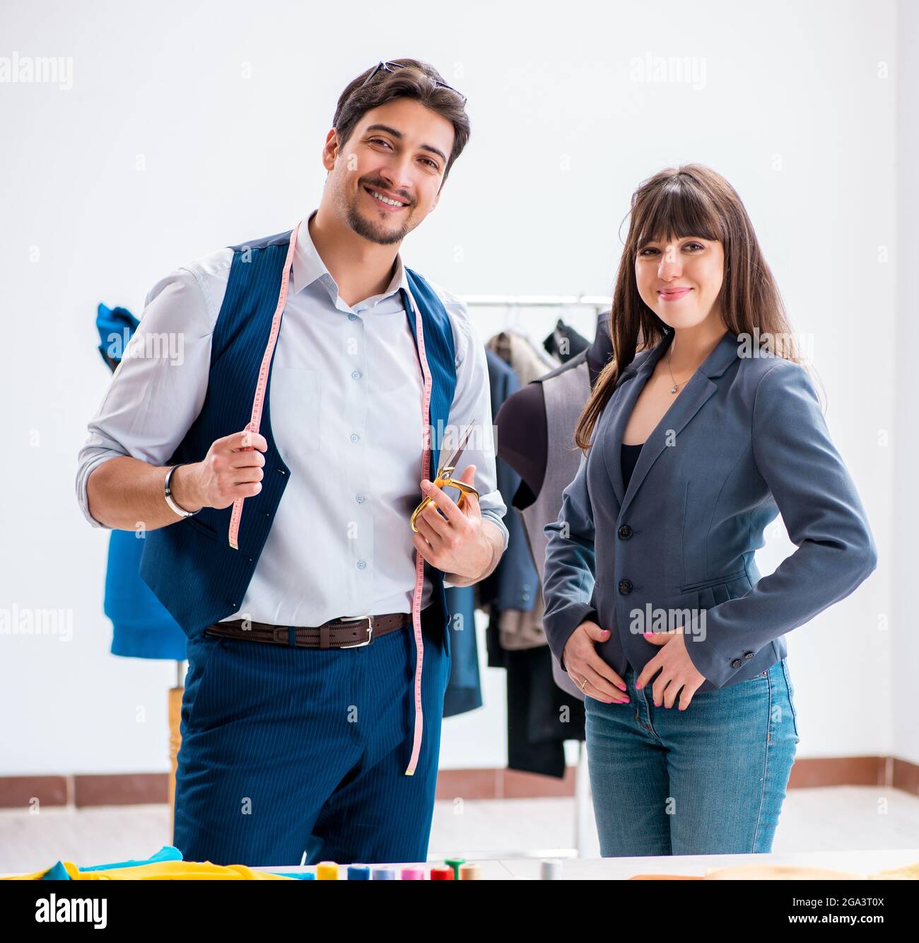 The professional tailor taking measurements for formal suit Stock Photo ...