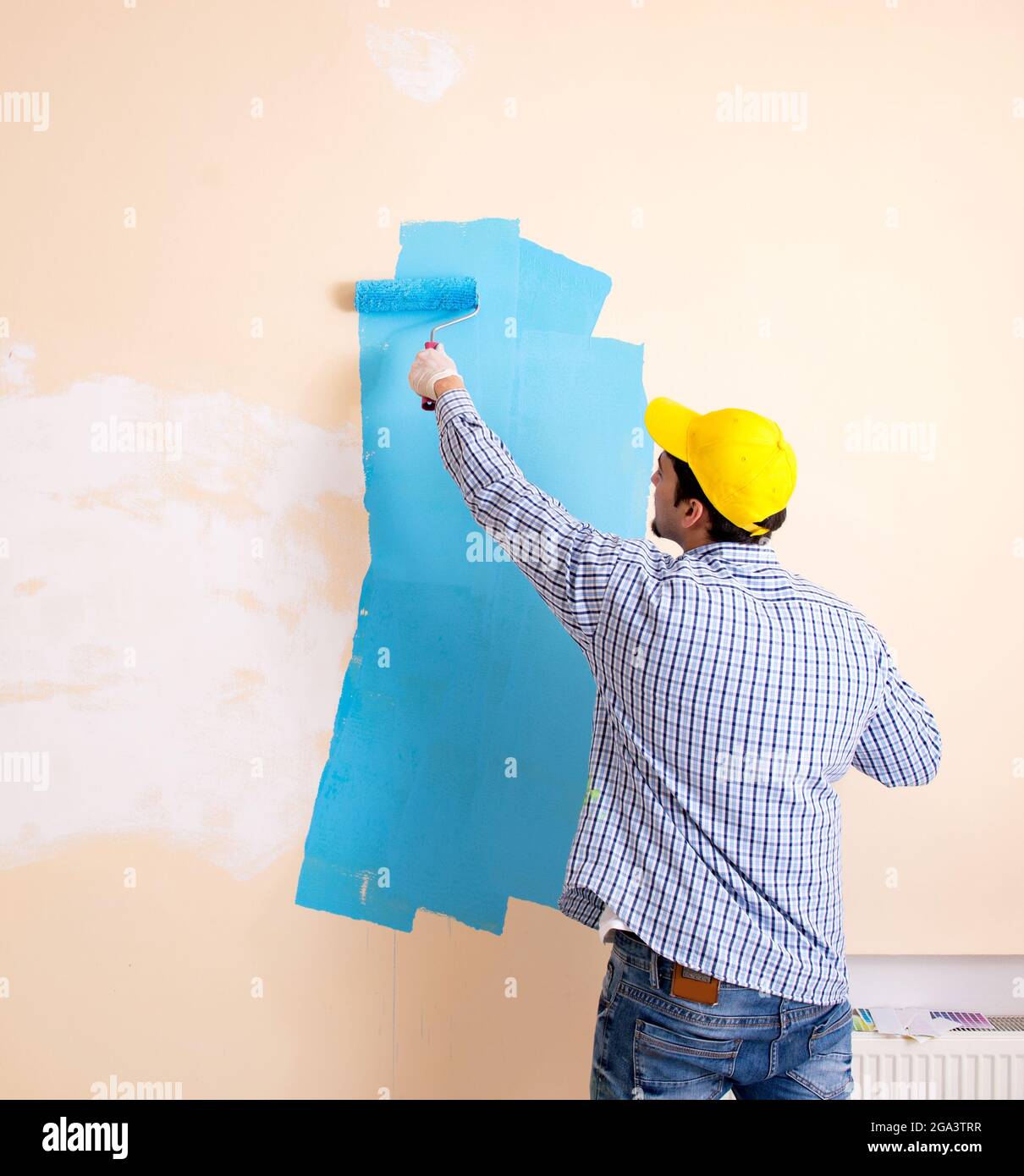 The painter man painting the wall at home Stock Photo - Alamy