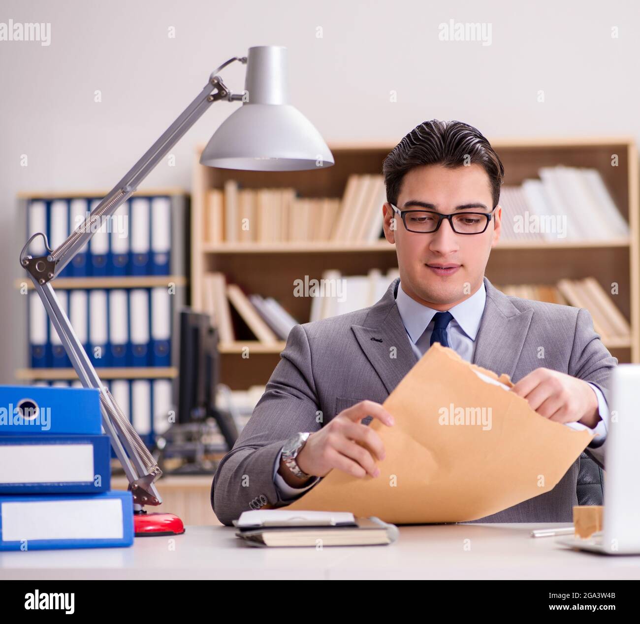 The businessman receiving letter in the office Stock Photo - Alamy
