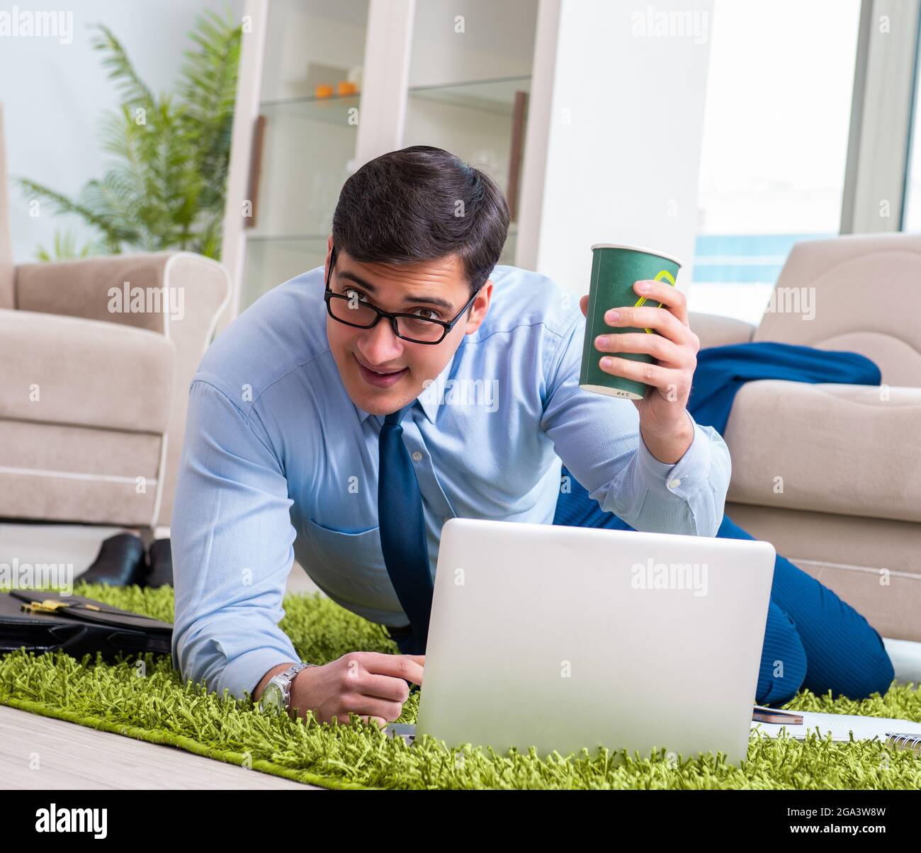 The businessman taking work home and working overtime Stock Photo - Alamy