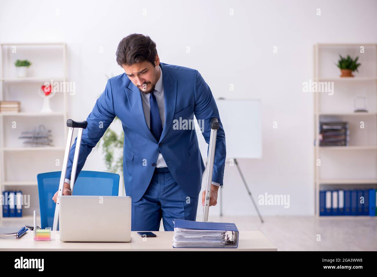 Young businessman employee after accident at workplace Stock Photo - Alamy