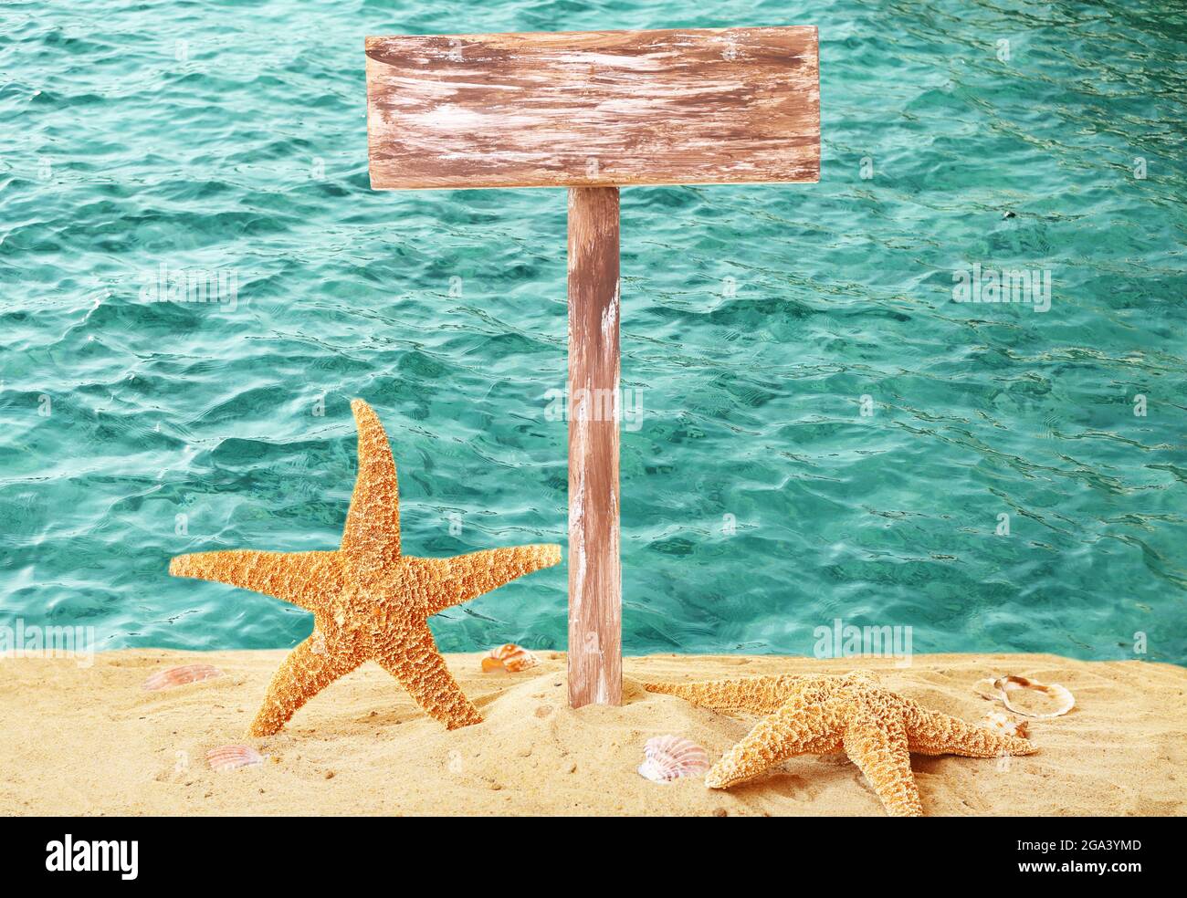 Wooden signboard with sand on sea background Stock Photo - Alamy