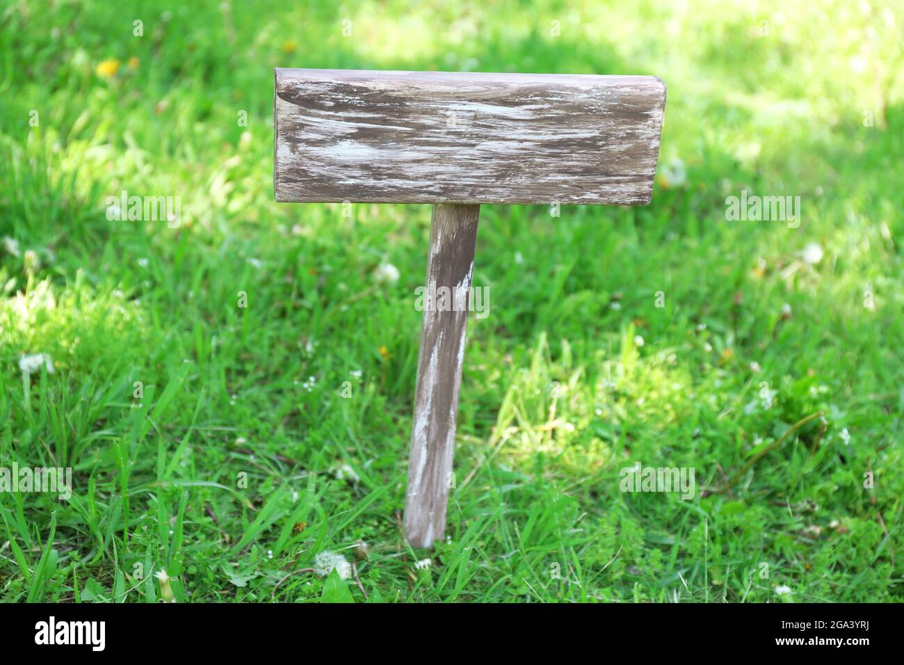 Wooden signboard over grass, outdoors Stock Photo - Alamy