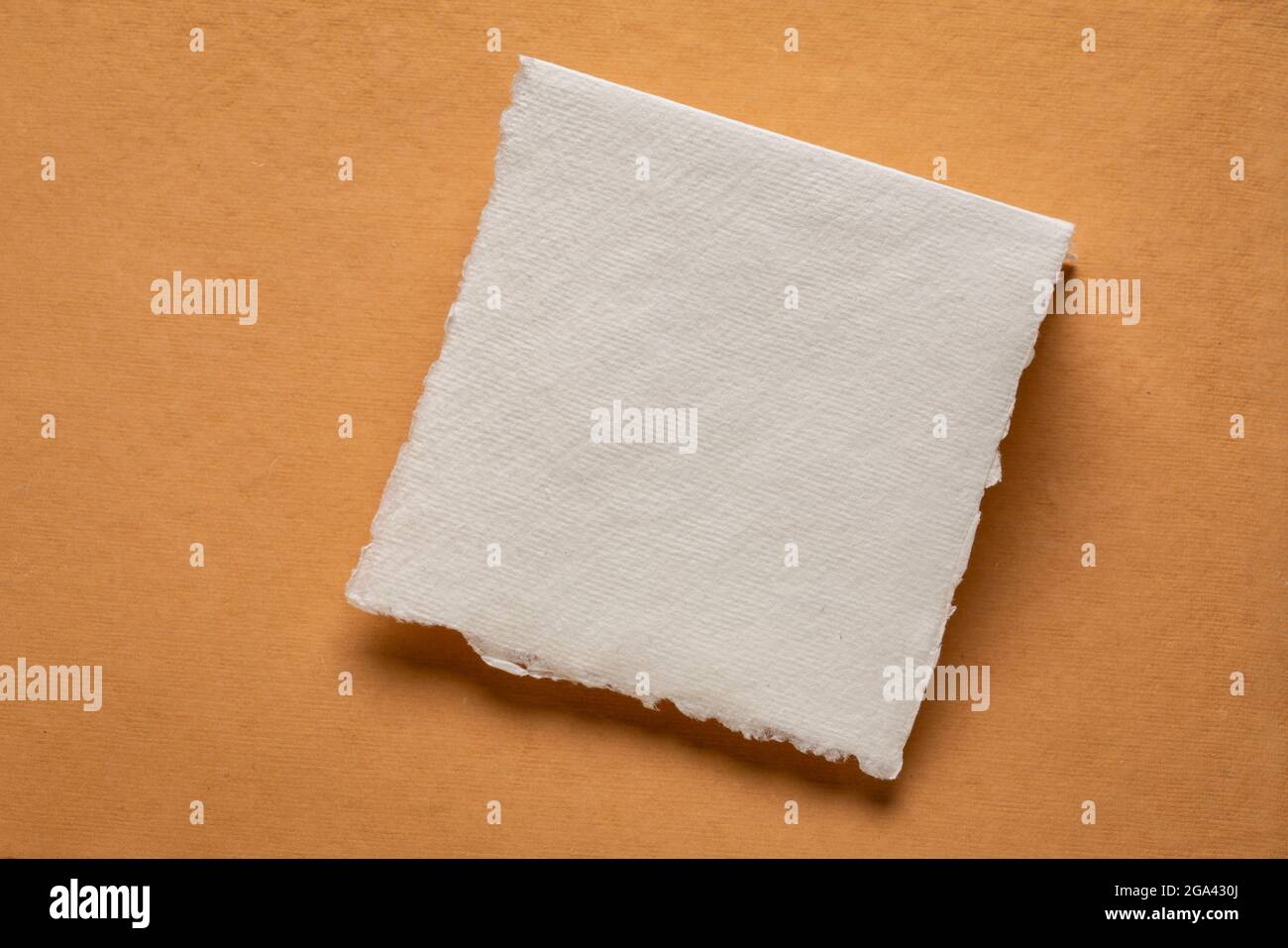 small sheet of blank white Khadi rag paper from South India orange ...