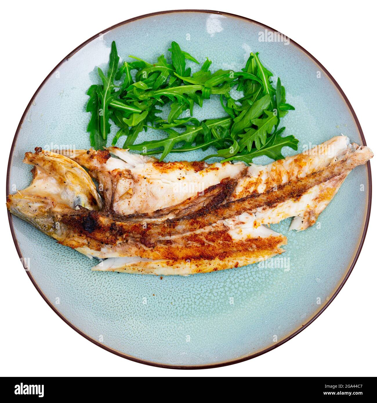 Grilled sea bass fish served with arugula Stock Photo - Alamy
