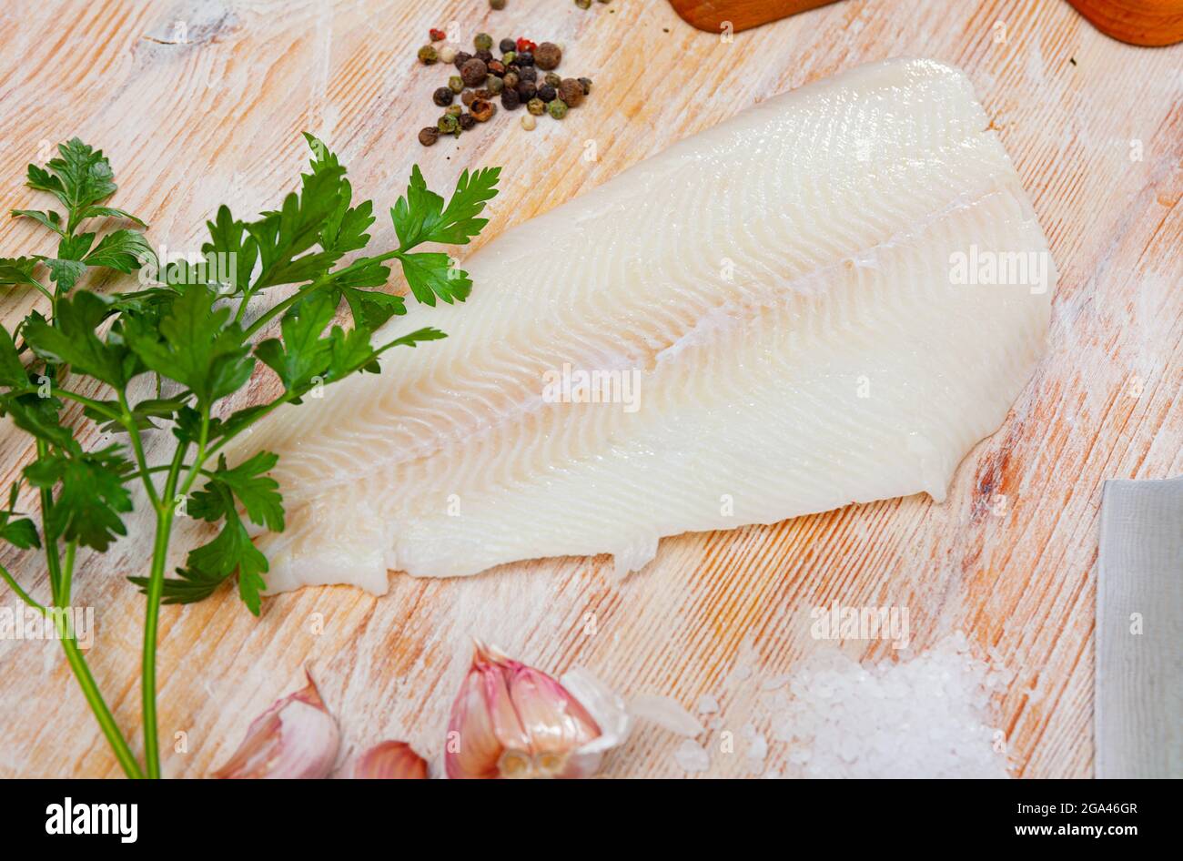 Raw Atlantic halibut fillet with condiments Stock Photo - Alamy