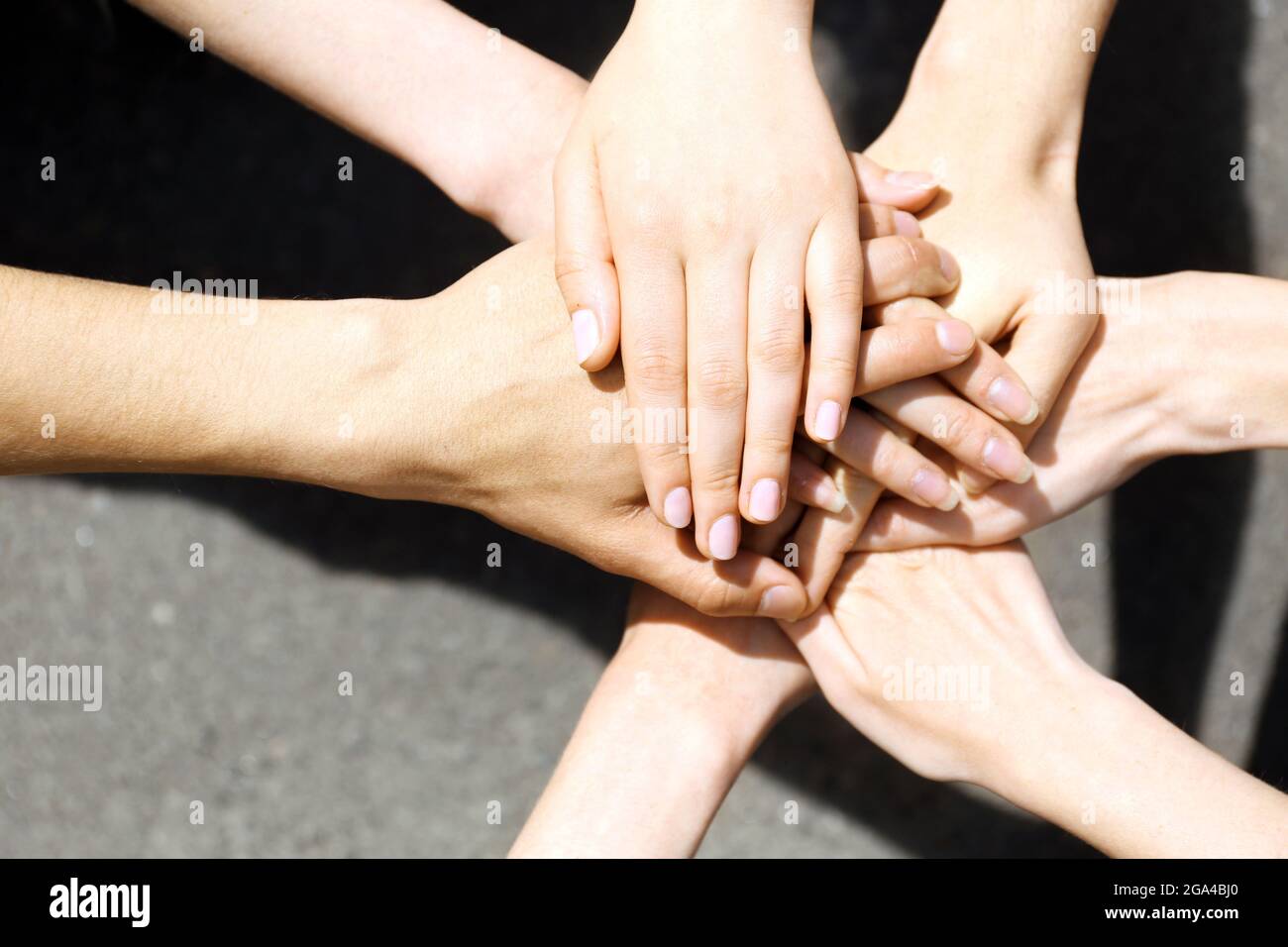 United hands outdoors Stock Photo - Alamy