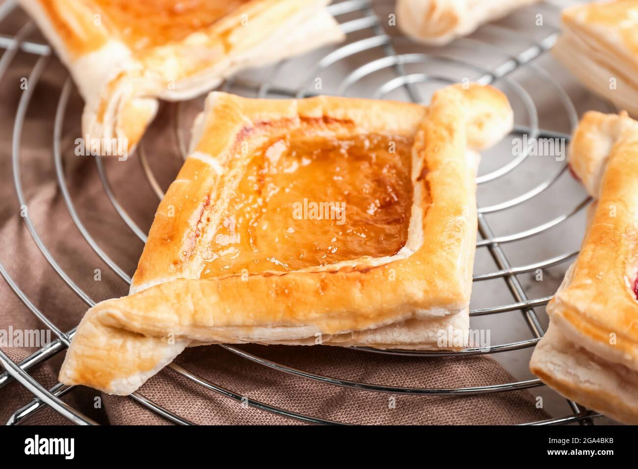 Cooling grid with Danish pastry on light background Stock Photo - Alamy