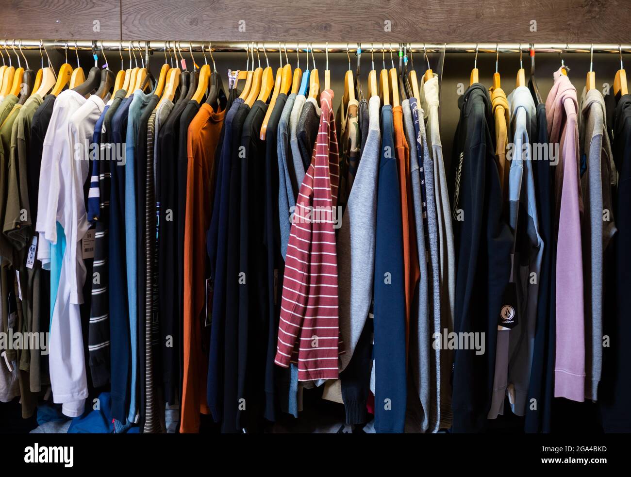 Assortment of summer clothing in modern store Stock Photo - Alamy