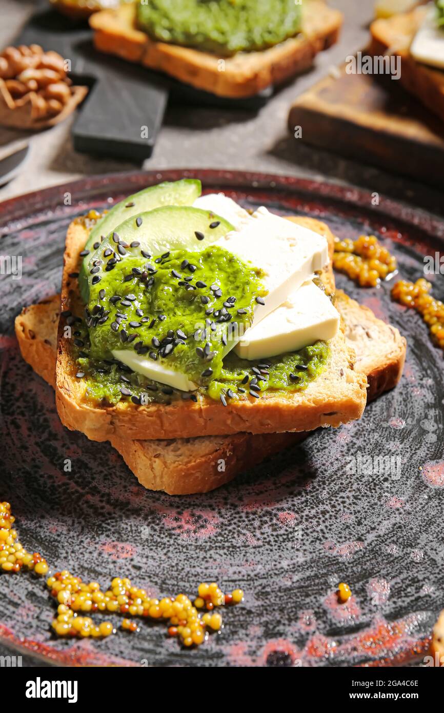 Tasty toast with pesto sauce on table, closeup Stock Photo - Alamy