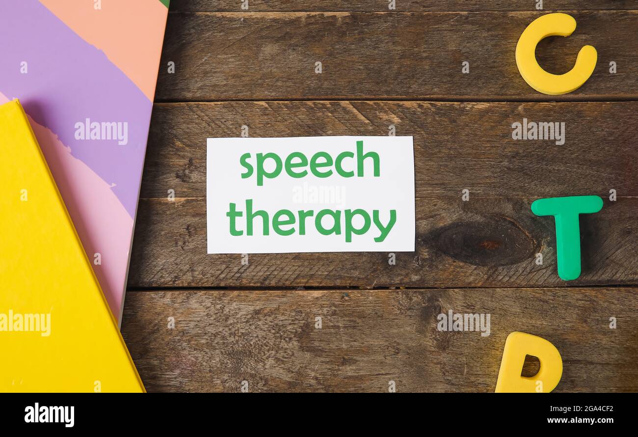 Paper with text SPEECH THERAPY and letters on wooden background Stock ...