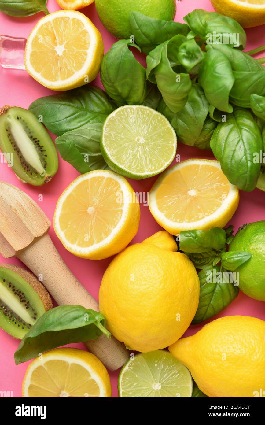 Basil leaves and citrus fruits on color background Stock Photo - Alamy