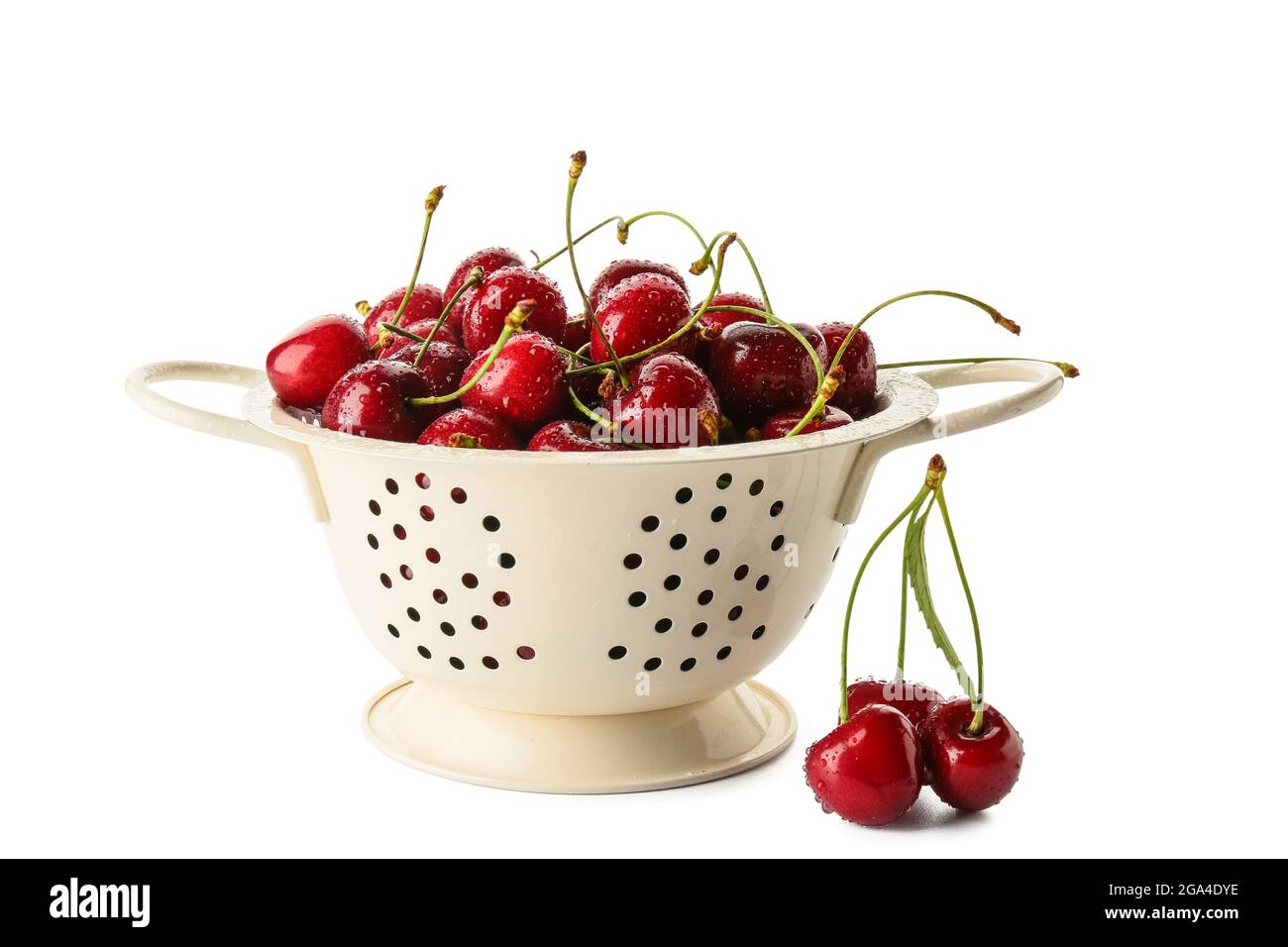 Colander with sweet cherry on white background Stock Photo - Alamy