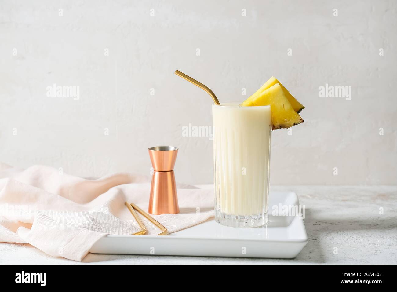 Glass with tasty Pina Colada cocktail on light background Stock Photo ...