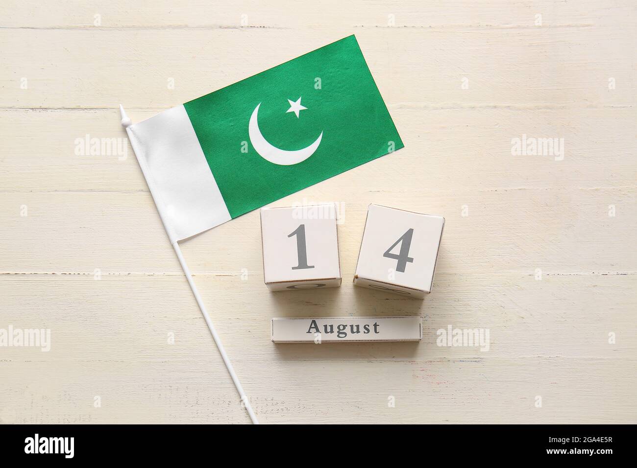 Flag of Pakistan and calendar with date of Independence Day on white ...
