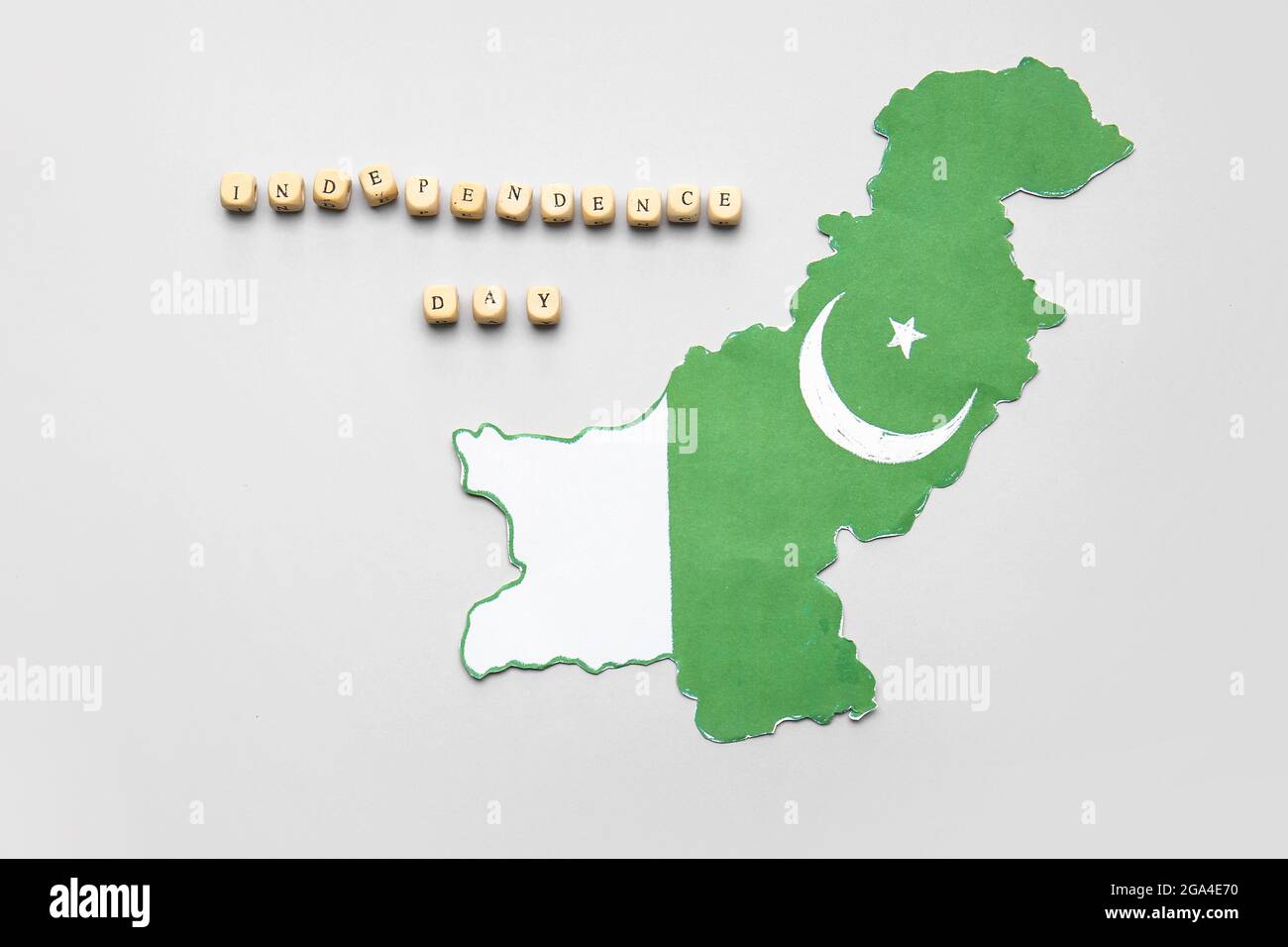 Flag map of Pakistan and text INDEPENDENCE DAY on light background ...