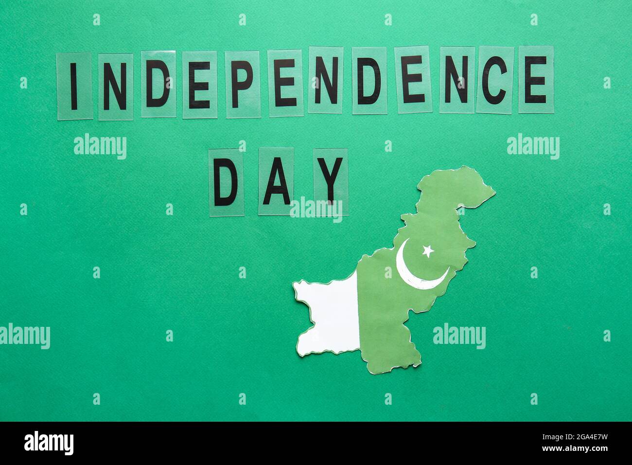 Flag map of Pakistan and text INDEPENDENCE DAY on color background ...