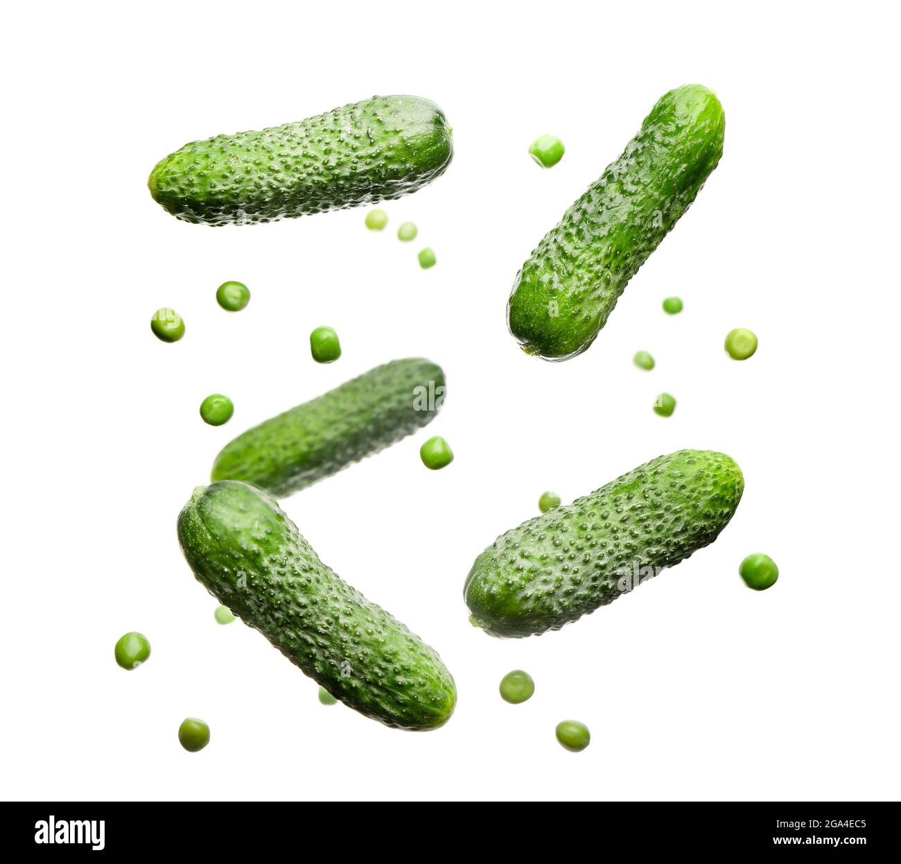 Flying green pea and cucumbers on white background Stock Photo - Alamy