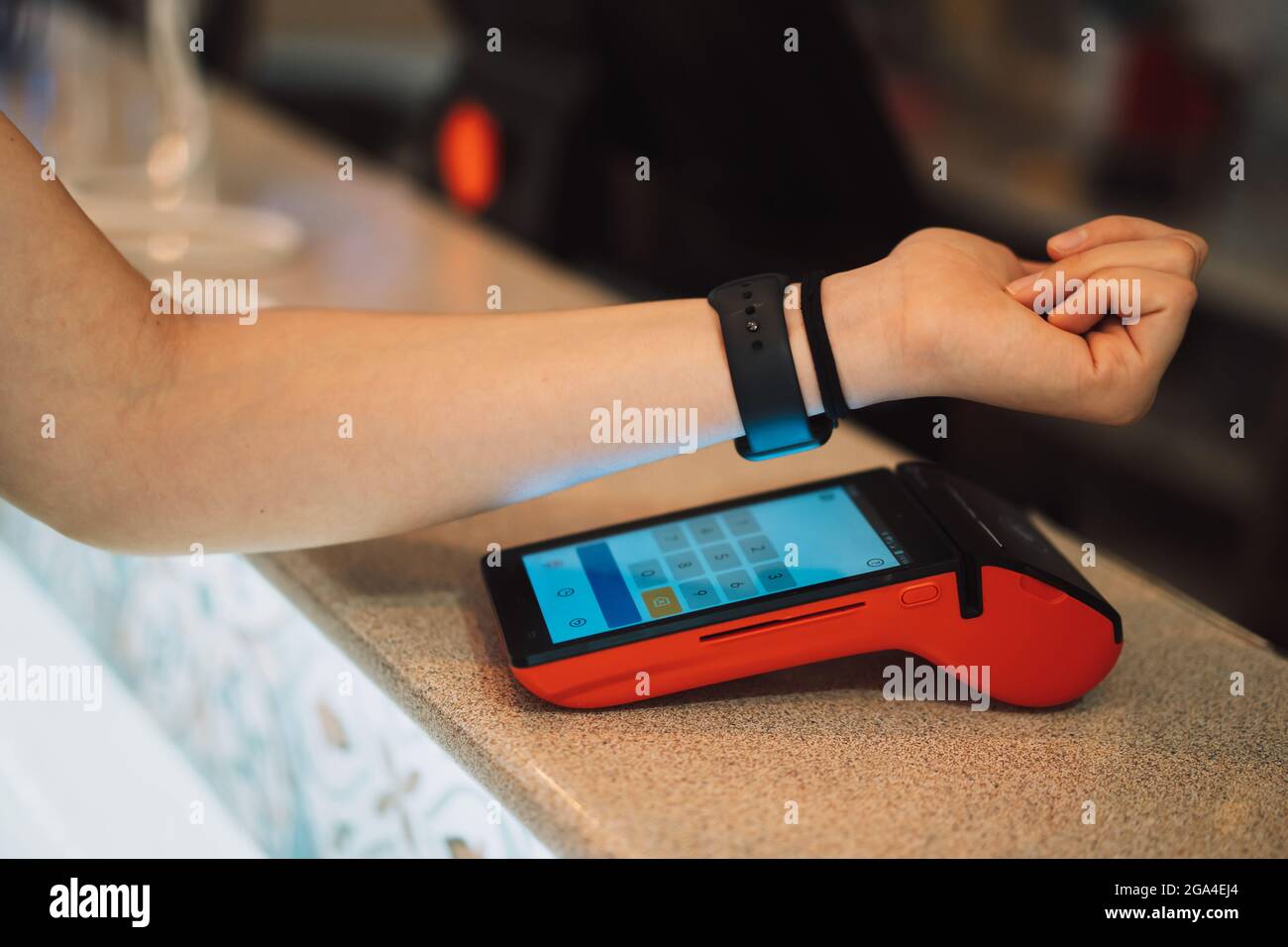 Contactless payment from watch via pos terminal Stock Photo - Alamy