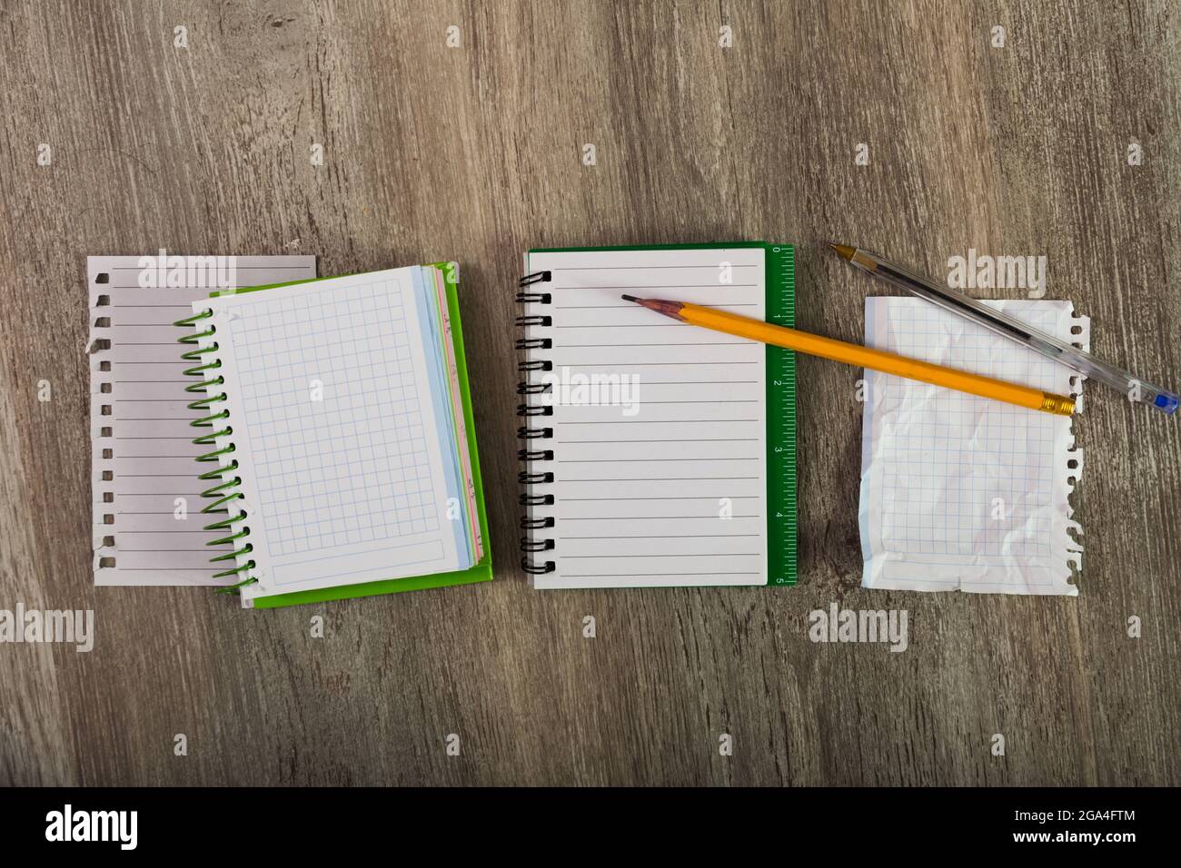 Torn sheets with notebooks and writing utensils Stock Photo - Alamy