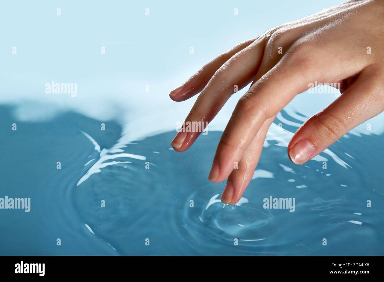 Finger touches water close up Stock Photo - Alamy
