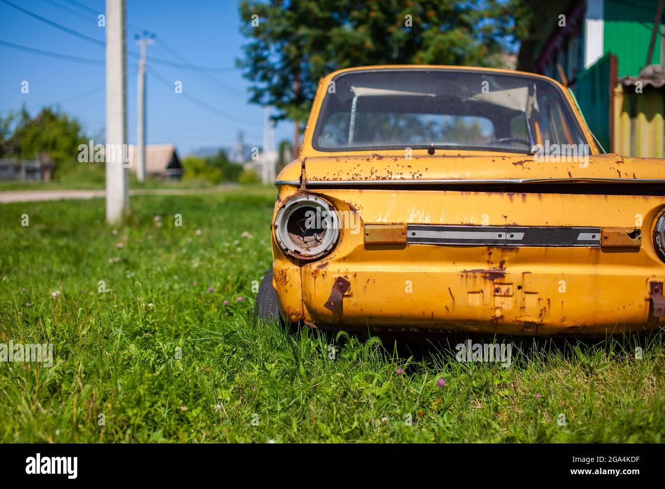 Old yellow wrecked car in vintage style. Abandoned rusty yellow car ...