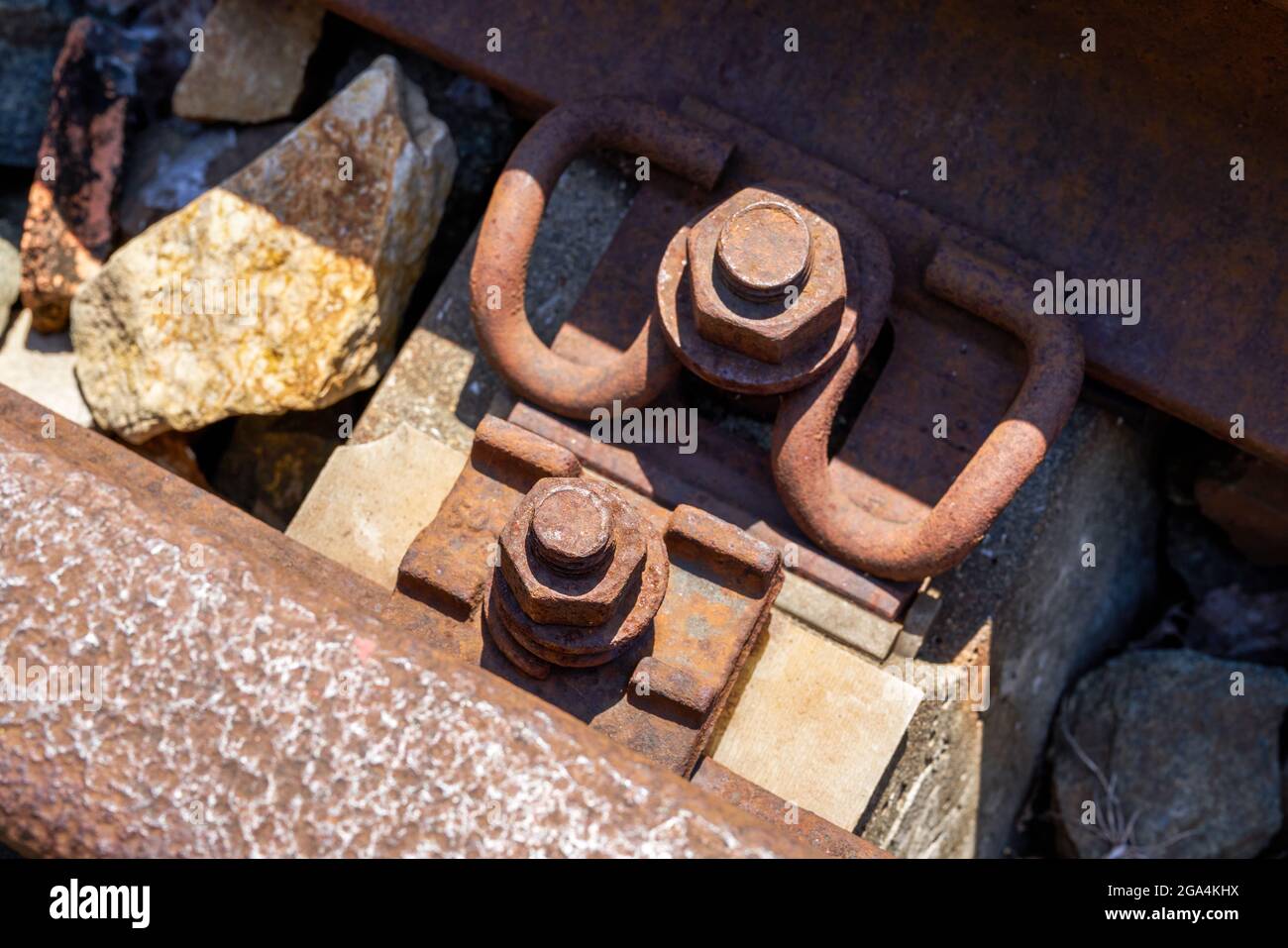 Closeup of old rusty railway bifurcated rails and rivets in the wild ...