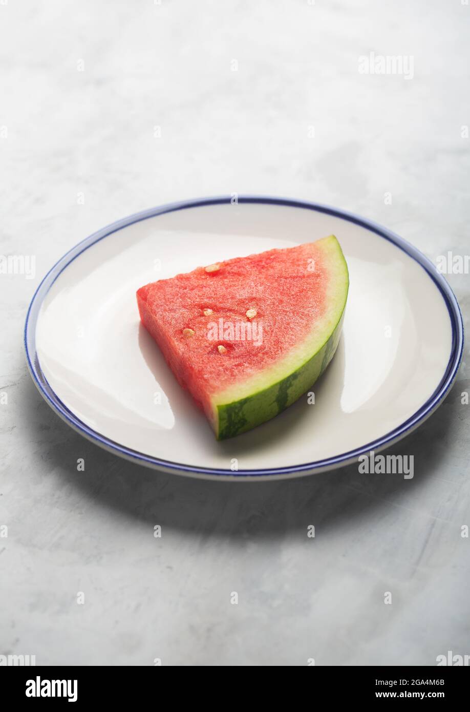 Large red raw watermelon pieces on the plate. It sweet, juicy flesh ...