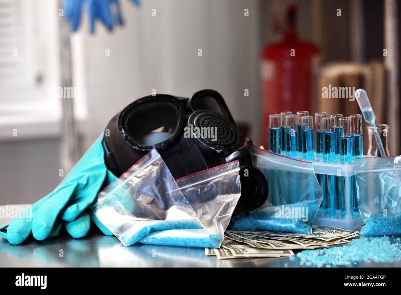 Drug laboratory: blue methamphetamine and money on table close up Stock ...
