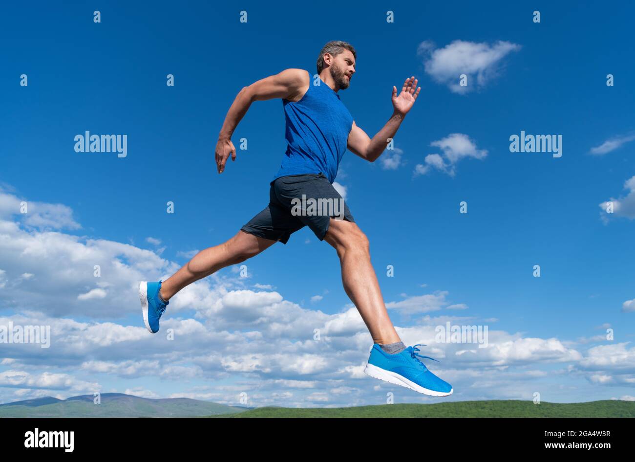 sportsman sprinter with muscular body running in sportswear outdoor on ...