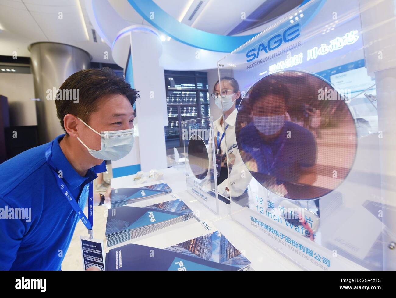 HANGZHOU, CHINA - JULY 29, 2021 - Visitors watch 300 mm wafers etched ...