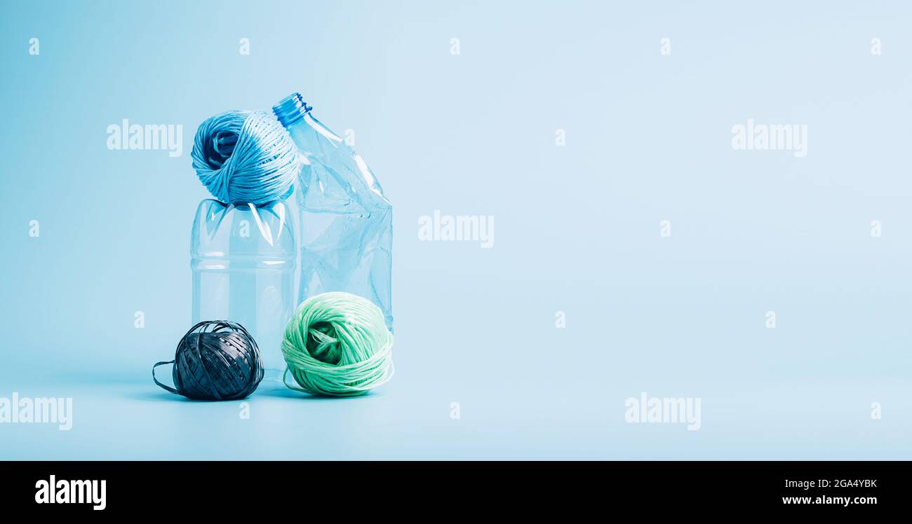 Plastic recycling and reuse concept. Empty plastic bottle and polyester ...