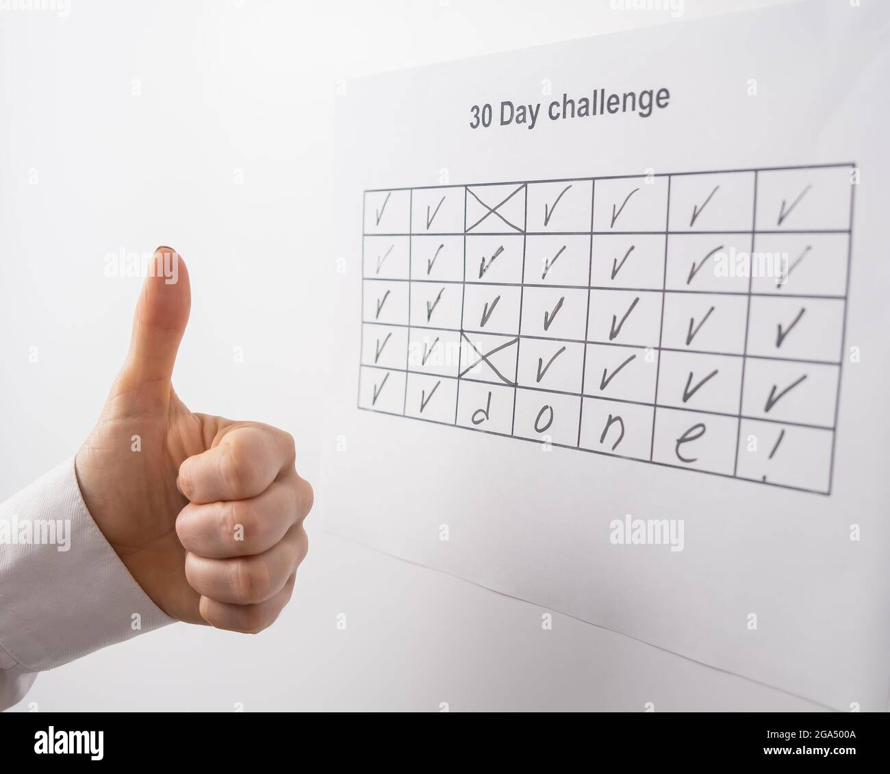 Cropped view of woman completing 30 days of challenge and showing thumb ...