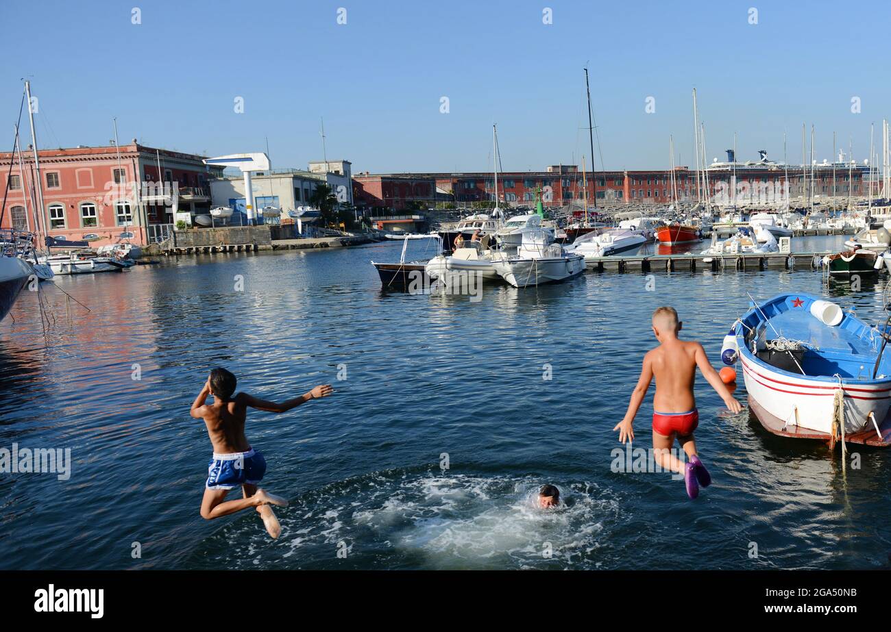Italian children jumping into the water at the Porticciolo Molosiglio ...